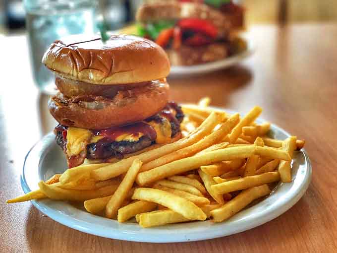 This isn't just another burger &ndash; it's a towering achievement of beef, cheese, and toppings that requires both hands and possibly a nap afterward.