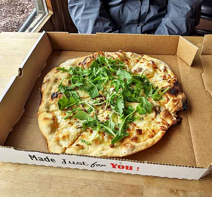This isn't your average white pizza&mdash;it's a canvas of creamy cheese topped with fresh arugula that might make you forget other pizzas exist.