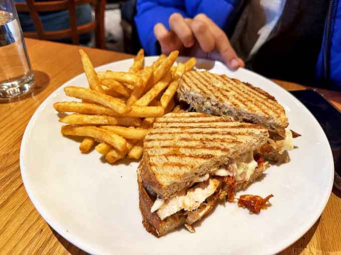 A perfectly grilled sandwich flanked by golden fries &ndash; because sometimes lunch crashes the breakfast party, and nobody's complaining.