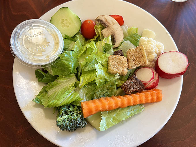 Not just any side salad &ndash; a fresh, vibrant garden of crisp vegetables that proves even the accompaniments get star treatment here.