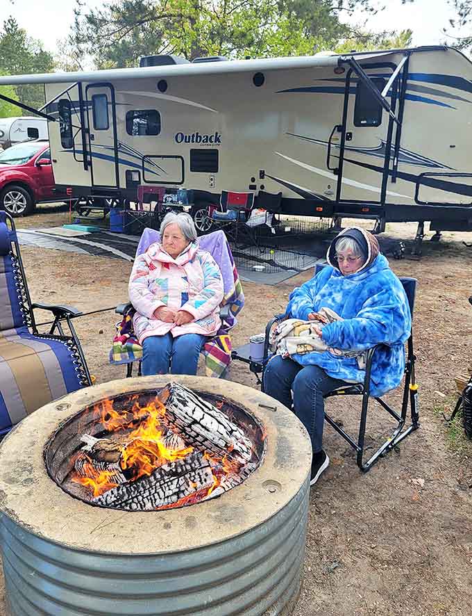 Bundled up by the fire, these campers have mastered the art of staying cozy while communing with nature.