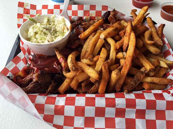 Golden fries and sides in checkered paper baskets deliver that classic barbecue joint aesthetic we all crave.