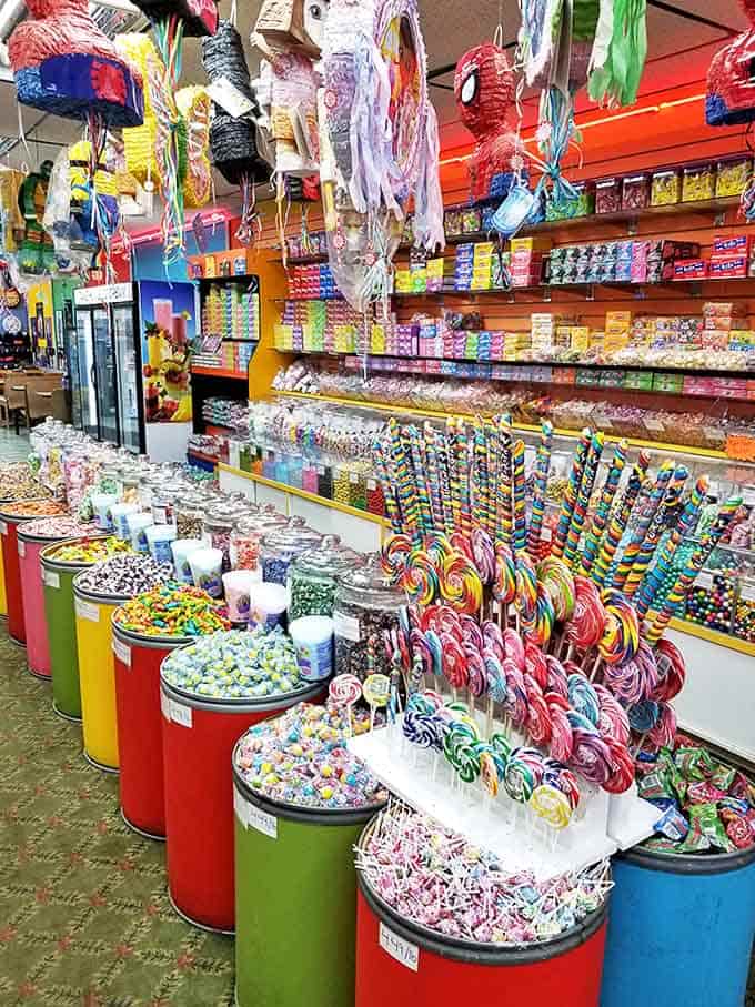 Candy barrels stand like colorful soldiers guarding a sugar kingdom, their rainbow contents promising adventures in flavor that transcend ordinary snacking experiences.