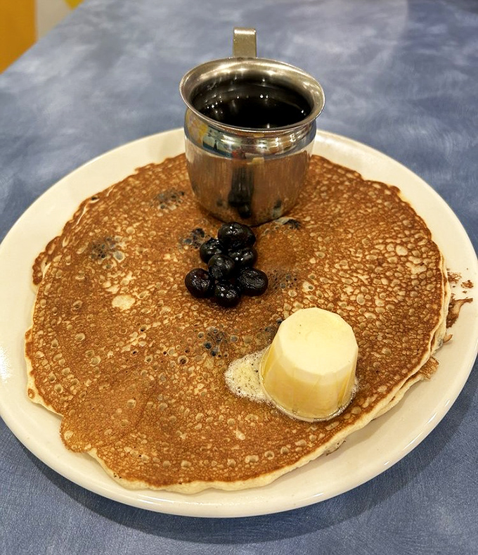 Their blueberry pancakes arrive with a pat of butter and warm syrup &ndash; thin, lacy-edged perfection that practically floats off the plate.