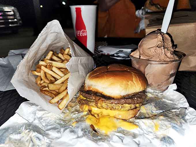 The holy trinity of drive-in dining: a perfectly melty cheeseburger, golden fries, and chocolate ice cream for the grand finale.