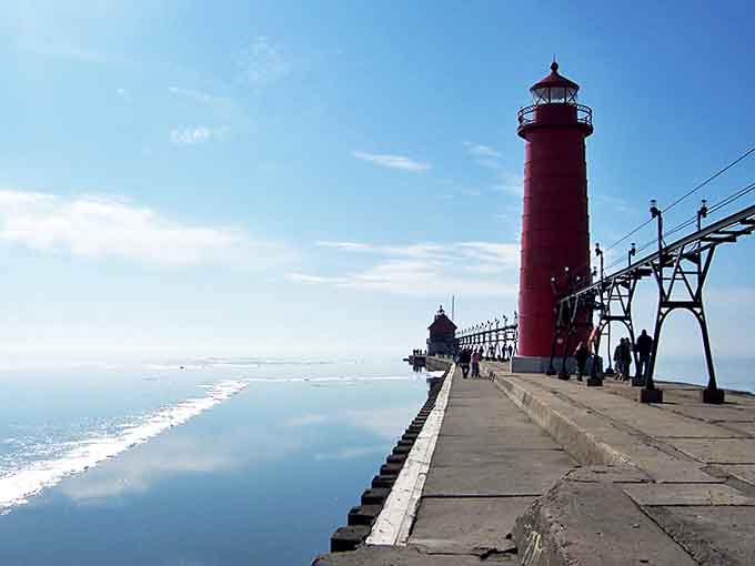Summer serenity at the Grand Haven Lighthouse, where blue skies and calm waters create a postcard-worthy Michigan moment.