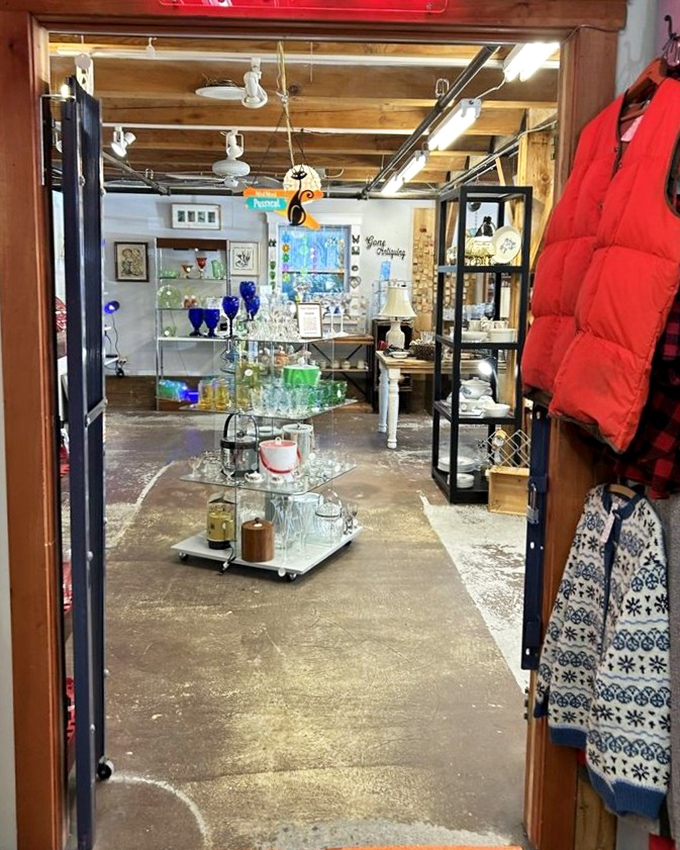 A welcoming doorway opens into the Vermont Antique Mall, where shelves of glass treasures sparkle under warm lights inviting curious wandering and discovery.