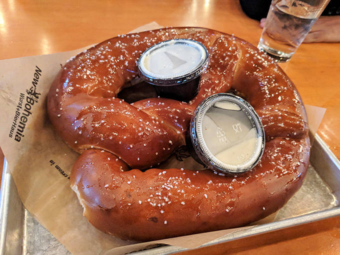 Two dipping sauces stand ready for duty, prepared to transform each tear of pretzel into a flavor adventure all its own.