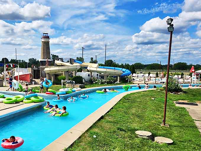 The lazy river winds through the park like a liquid blue ribbon, carrying happy floaters on the most relaxing journey this side of naptime.