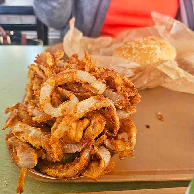 These aren't just onion rings &ndash; they're crispy golden halos of happiness that shatter perfectly with each bite. Worth the trip alone!