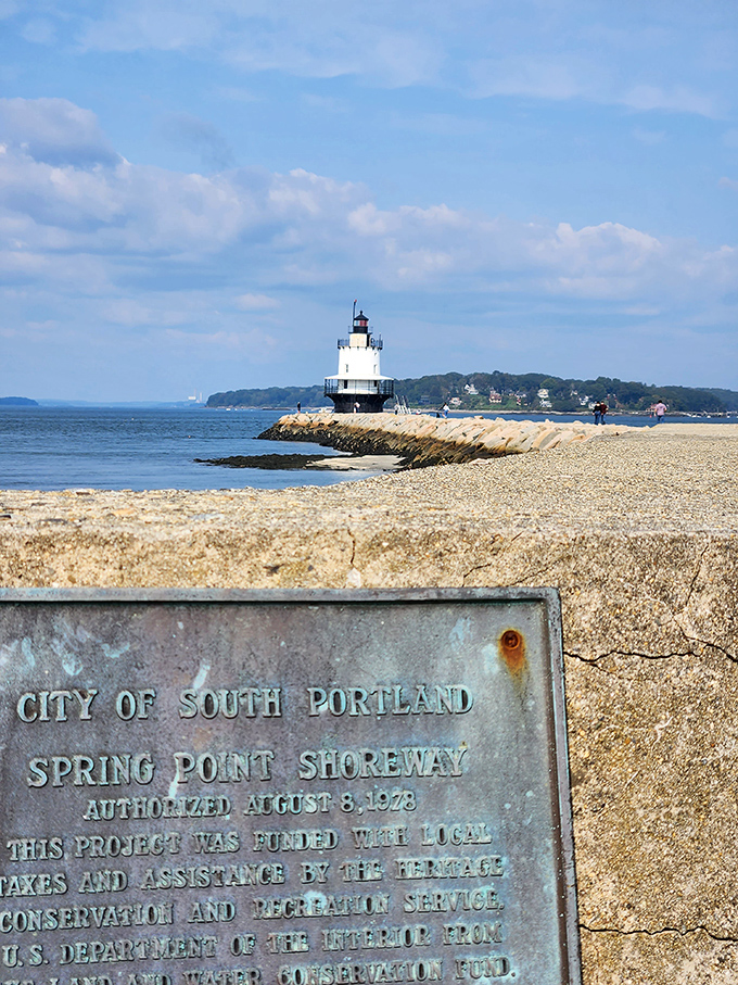 A weathered plaque tells the story of Spring Point Shoreway, connecting visitors to the site's rich maritime heritage.