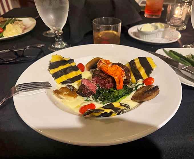 This artistic surf and turf presentation transforms dinner into theater, with perfectly cooked steak and seafood arranged on a canvas of creamy sauce.