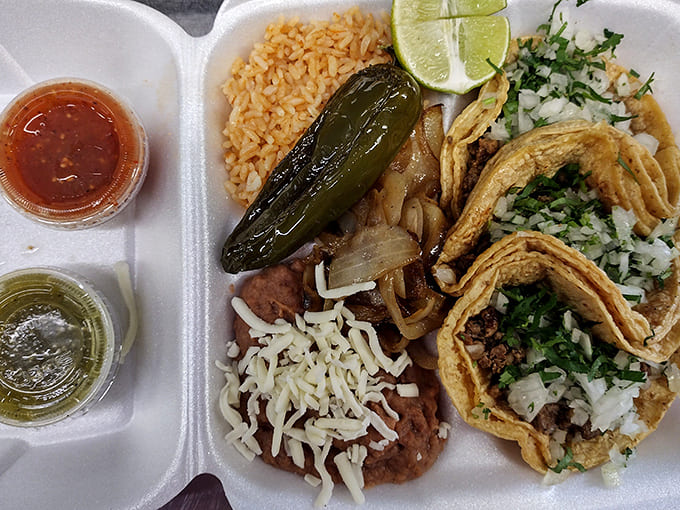 The complete experience: Tacos paired with Mexican rice, beans, and a roasted jalapeño – comfort food that speaks a universal language.