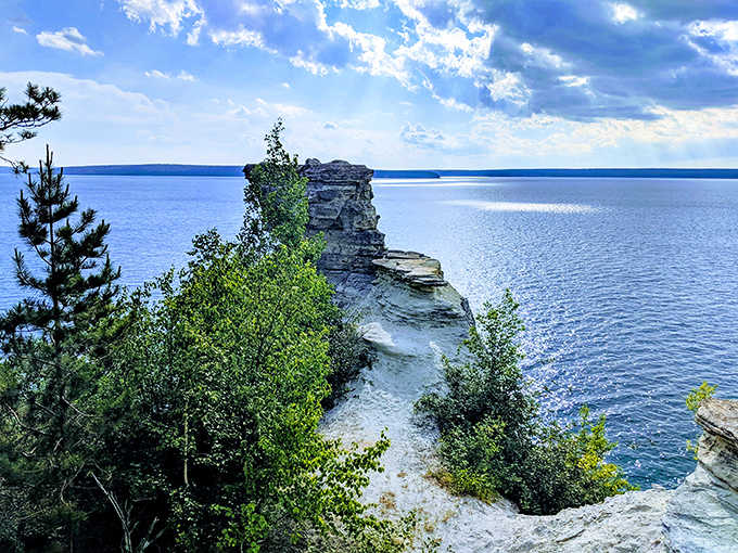 The view from above reveals Lake Superior's stunning gradient of blues against the rugged shoreline &ndash; worth every step of the hike.