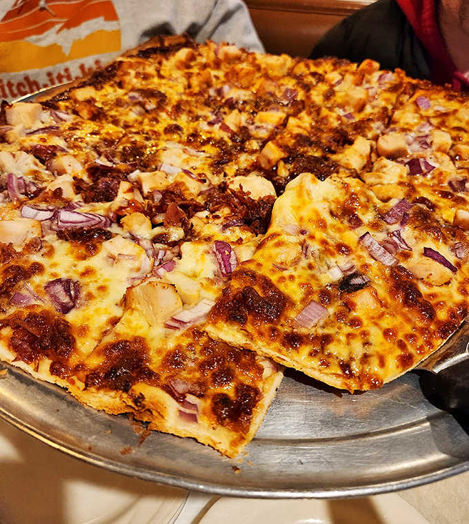 BBQ chicken pizza with its sweet-tangy sauce, tender chicken chunks, and red onions offers a delicious twist on tradition.