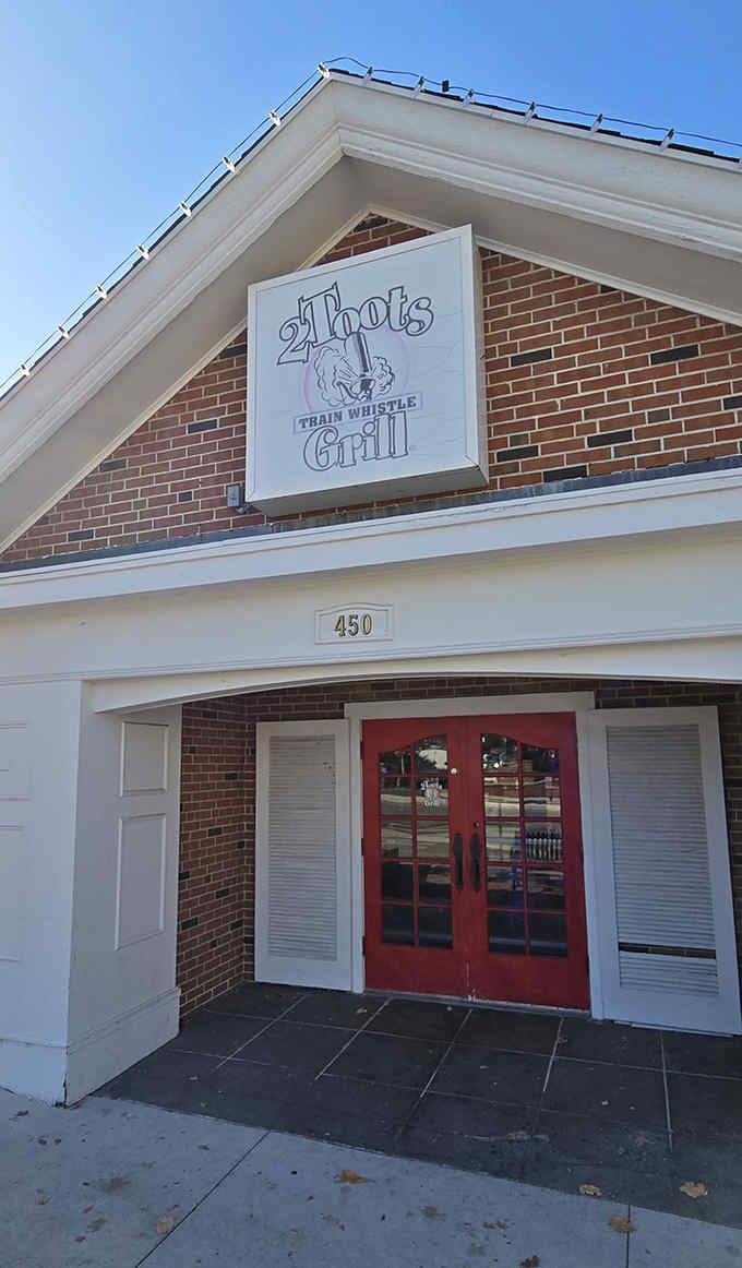The charming exterior of 2Toots Train Whistle Grill hints at the railroad fun inside, where miniature trains deliver burgers straight to your table.
