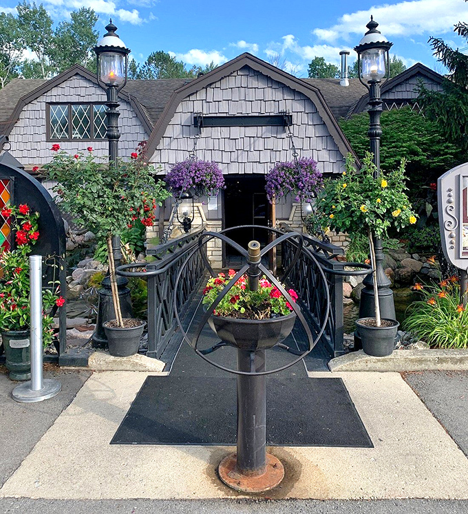 A flower-lined pathway leads visitors to The English Inn's entrance, where an enchanting dining experience awaits inside.