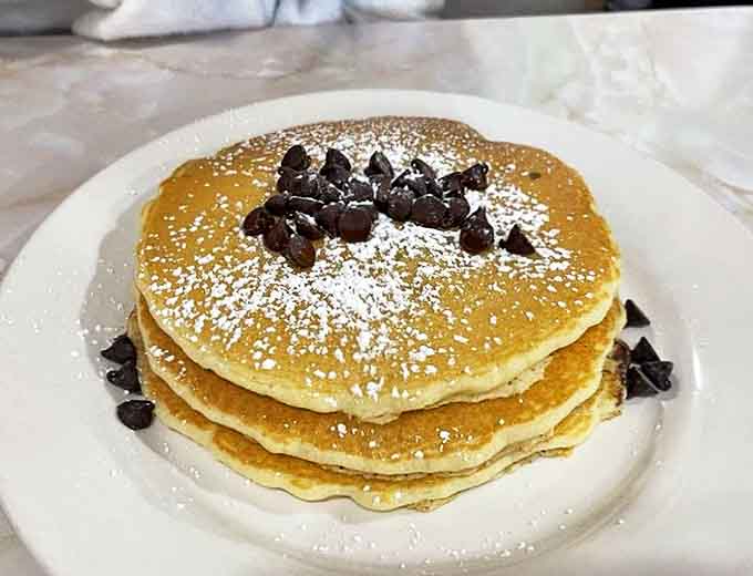 Chocolate chip pancakes that make adults remember why being a kid was so great &ndash; fluffy, golden discs studded with melting chocolate and dusted with powdered sugar.