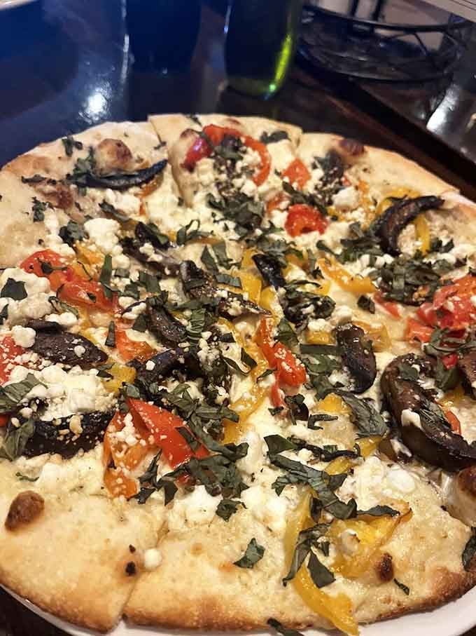 Roasted vegetables and goat cheese on a perfectly charred crust, making pizza feel almost virtuous and entirely delicious.