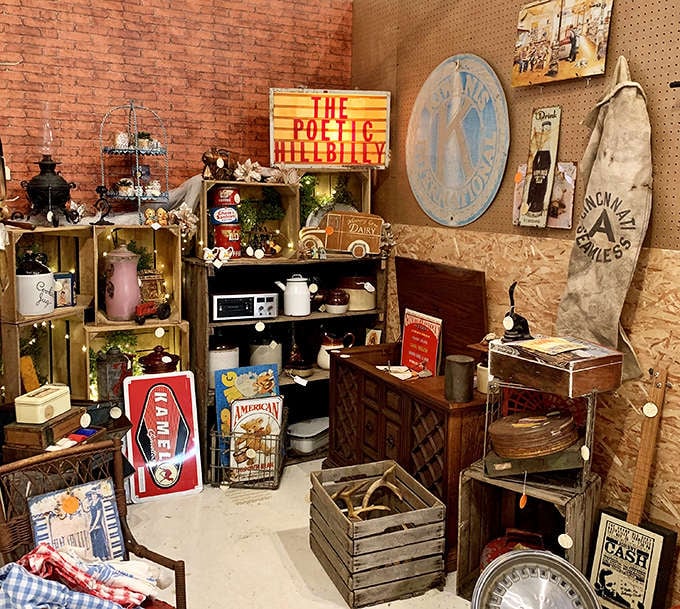 This booth celebrates Americana with "The Poetic Hillbilly" sign presiding over a collection of rustic treasures and vintage kitchenware.