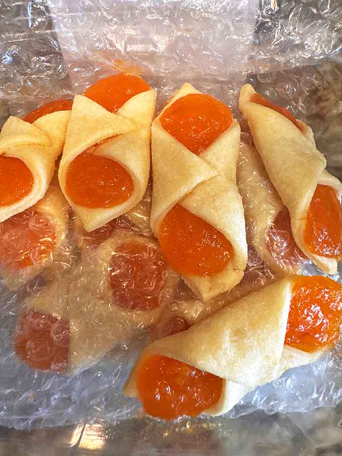 Apricot kolachi cookies bring sunshine to any day, their bright fruit centers winking like edible jewels from their pastry nests.
