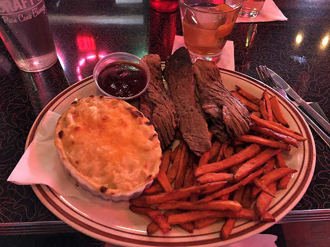 Tender, slow-smoked beef sharing the spotlight with mac and cheese so creamy it should require a permit in at least three states.