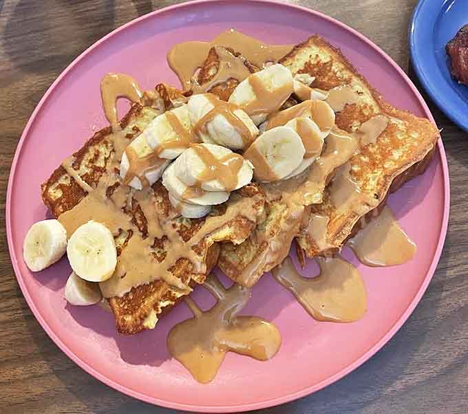 French toast elevated to art form &ndash; bananas and peanut butter drizzle create a sweet symphony that would make Elvis himself swoon.