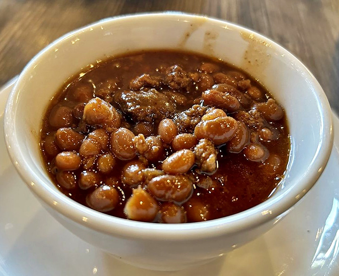 These aren't your cafeteria baked beans &ndash; they've been simmering with purpose, absorbing smoke and spice until transformed.