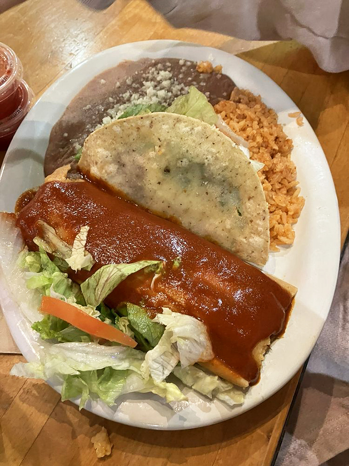 The classic combo plate – where a saucy enchilada and crispy taco become best friends on a bed of Spanish rice and beans.
