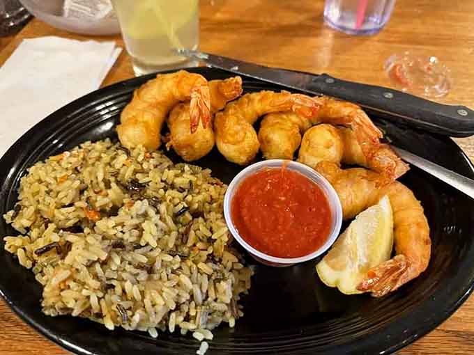 Golden fried shrimp paired with seasoned rice creates a satisfying alternative for those rare souls who skip the beef.