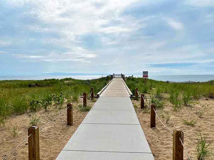 The boardwalk creates a pathway through delicate dunes, protecting the ecosystem while guiding visitors to sandy perfection.
