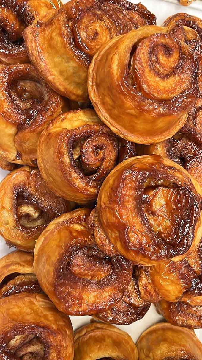 A mountain of cinnamon rolls so beautiful they should probably be in a museum, except museums don't let you eat the exhibits.