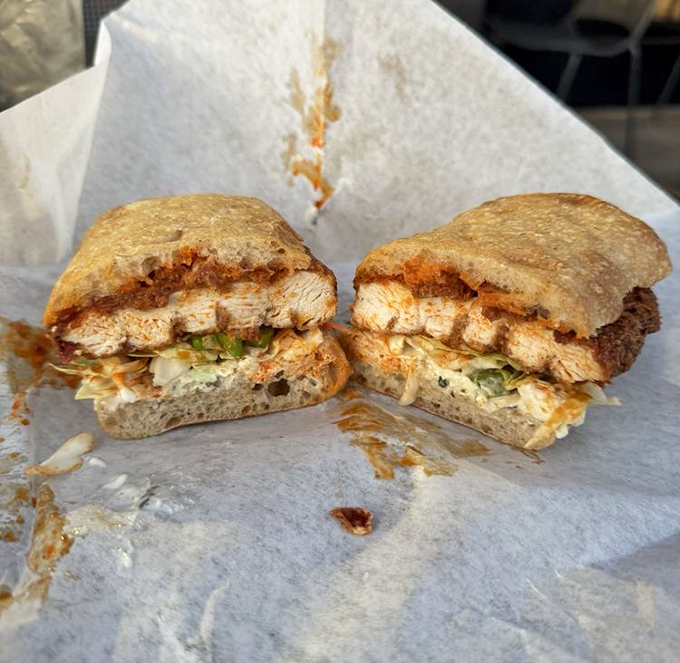 Split down the middle to reveal its glorious cross-section, this sandwich's vibrant filling promises a flavor explosion with every bite.