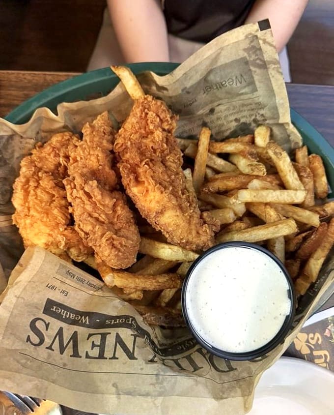 Perfectly crispy chicken tenders nestled alongside golden fries &ndash; comfort food elevated to an art form and served with house-made dipping sauce.