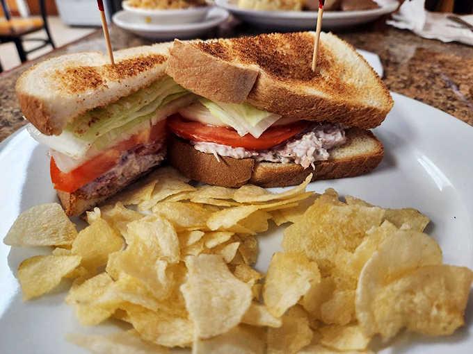 A club sandwich that requires both hands and a strategy &ndash; layers of freshness stacked between toast with chips that audibly crunch with each bite.