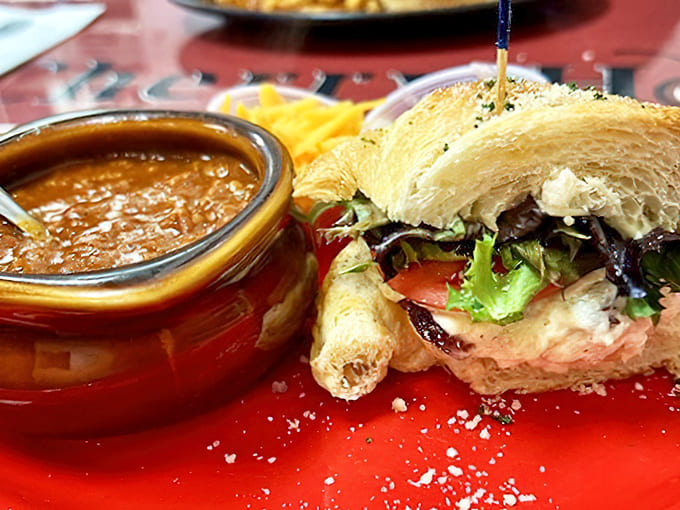 Comfort in a bowl meets artistry on a plate – hearty chili alongside a sandwich that's clearly been assembled by someone who cares.