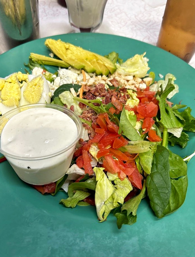 The Cobb salad arrives as an edible color wheel &ndash; crisp greens, creamy avocado, and protein aplenty for the virtuous road tripper.