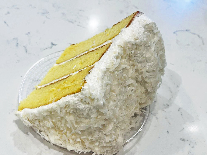 Coconut cake that makes you question whether clouds might actually taste this good if only they were edible.
