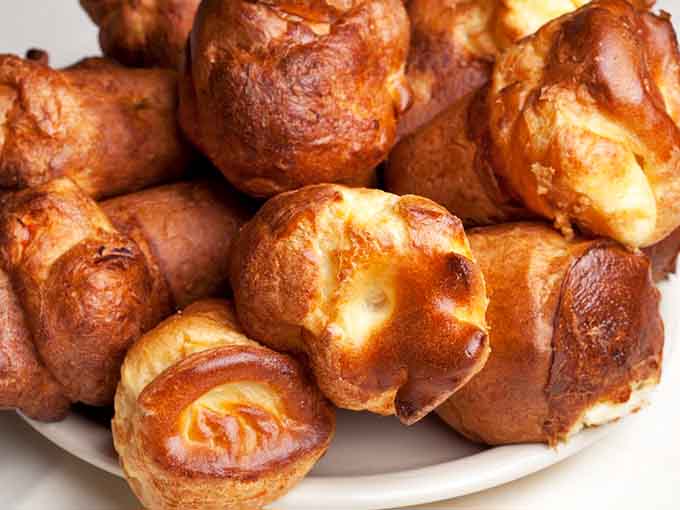These golden popovers are crispy outside, airy inside, and dangerously addictive before your main course even arrives.