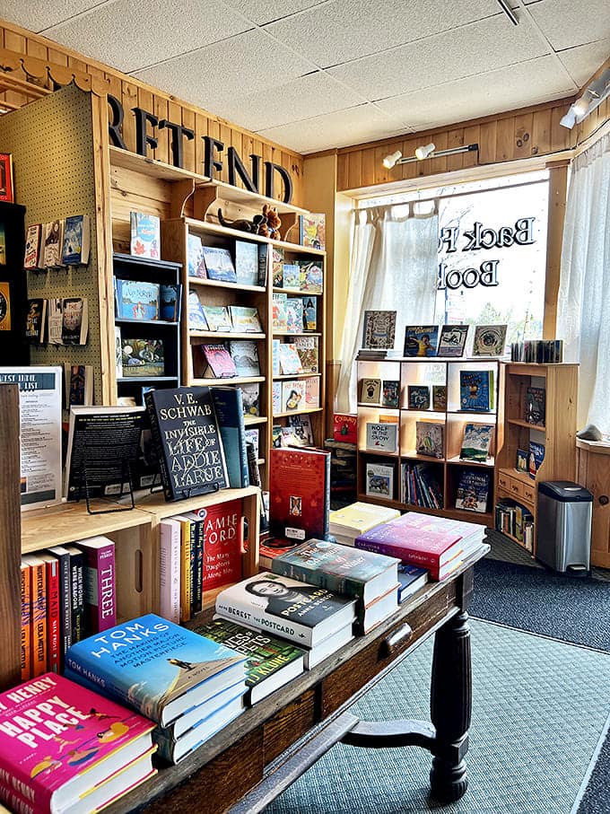 The "PRETEND" sign marks the children's section, where young imaginations find fuel for dreams and adventures between colorful covers.