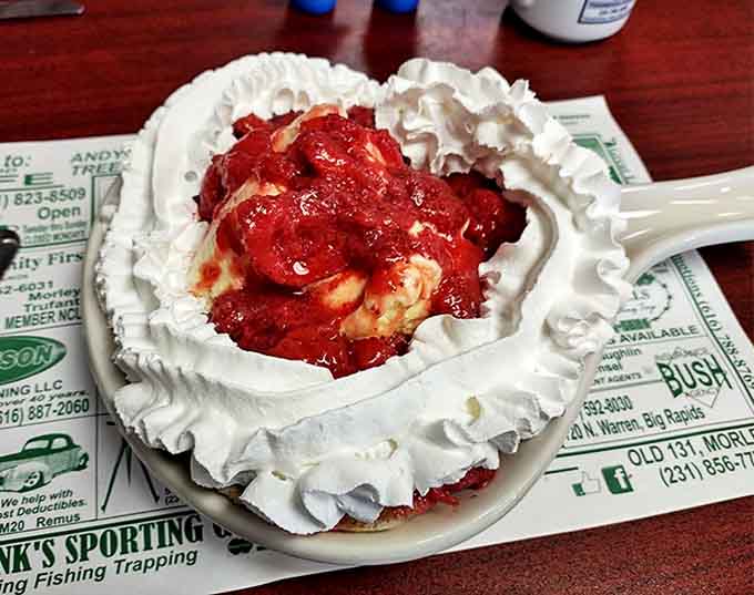 This strawberry dessert isn't just served &ndash; it's presented with whipped cream clouds and berry-stained sweetness.