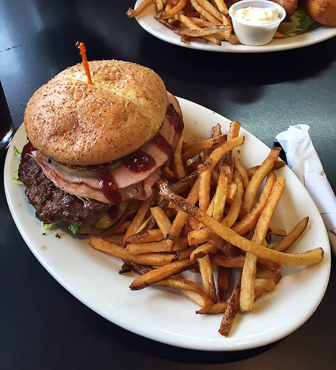 The Aloha burger brings tropical vibes to Ohio with grilled pineapple creating sweet and savory harmony on a bun.