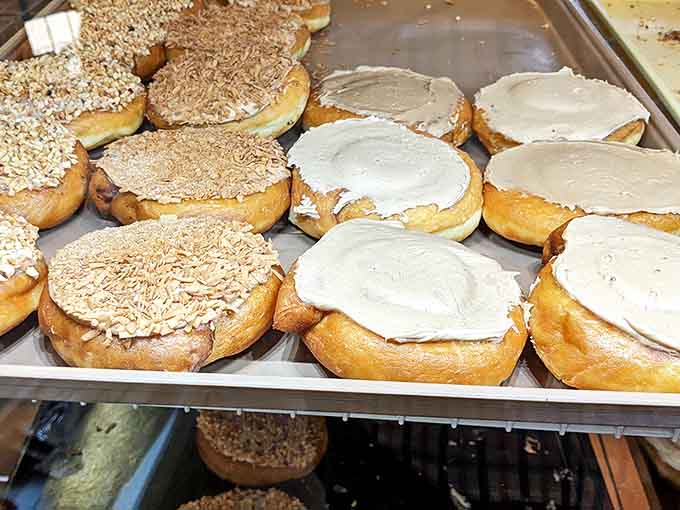 Donuts: Frosted masterpieces lined up like edible art – some topped with toasted coconut, others with creamy frosting that melts on your tongue.