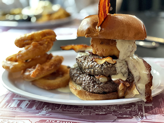 Behold the double-patty masterpiece &ndash; layers of beef, bacon, and cheese that somehow maintain structural integrity despite their magnificent height.