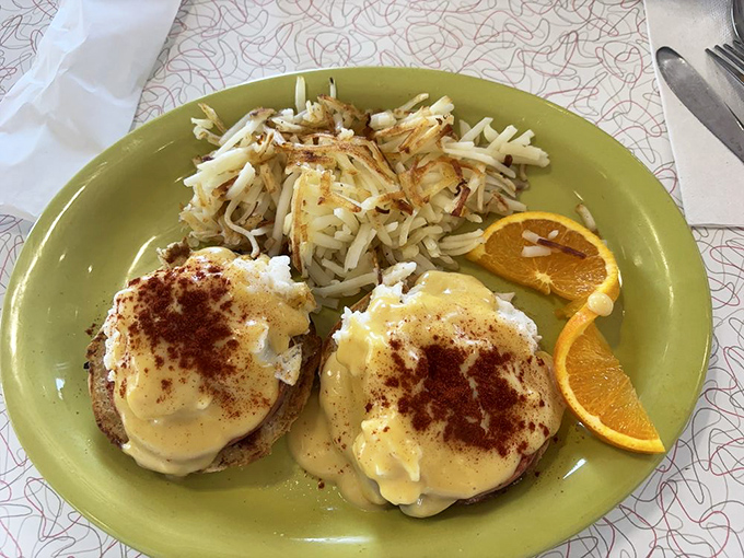 Eggs Benedict that would make any breakfast enthusiast weak in the knees, complete with perfectly crispy hash browns.