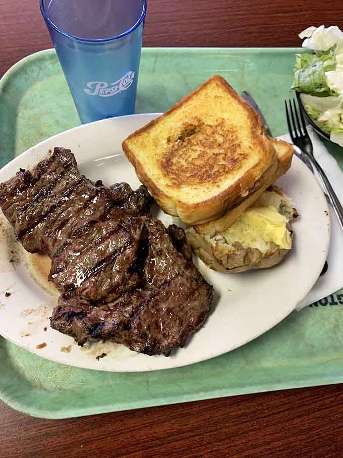 A ribeye cooked to perfection with a fluffy baked potato, because sometimes you need to see where that famous sandwich meat comes from.
