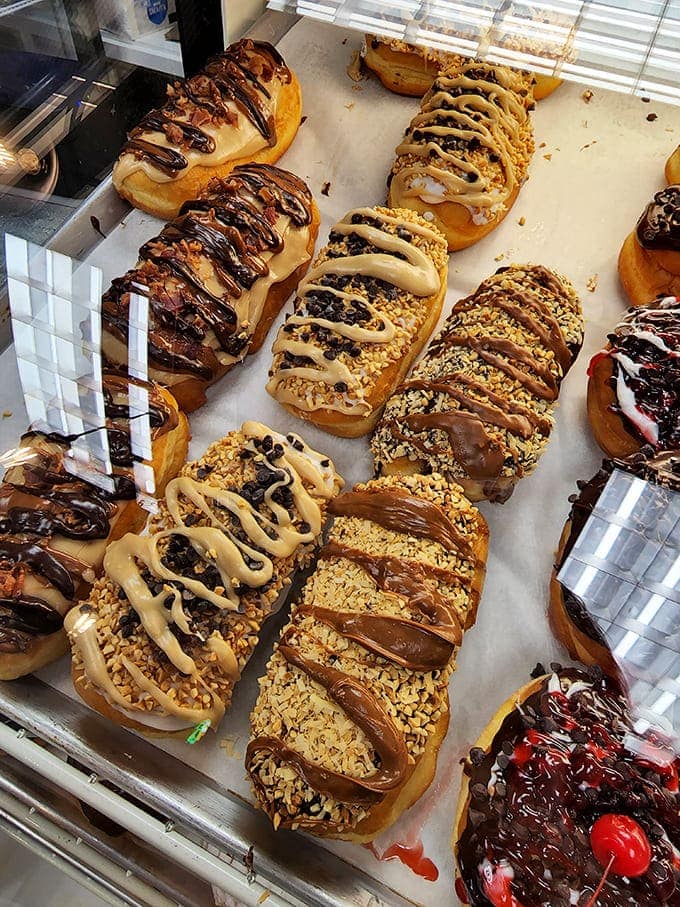 These filled donuts aren't playing around &ndash; they're packed to bursting with creamy fillings and topped with drizzles that make each one a unique masterpiece.