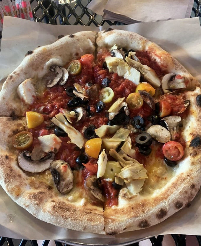A garden party on dough &ndash; artichokes, mushrooms, and colorful tomatoes celebrate vegetarian bliss on this artisan creation.