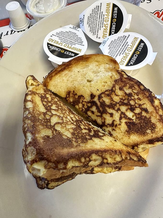 French toast that makes ordinary bread transcend to breakfast royalty &ndash; crispy edges, custardy center, and maple syrup's perfect partner.