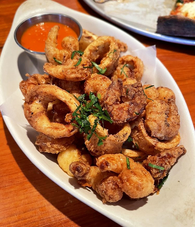 The fritto misto arrives golden and crisp, each morsel of seafood perfectly cooked within its light batter jacket &ndash; the kind of appetizer that disappears in minutes.